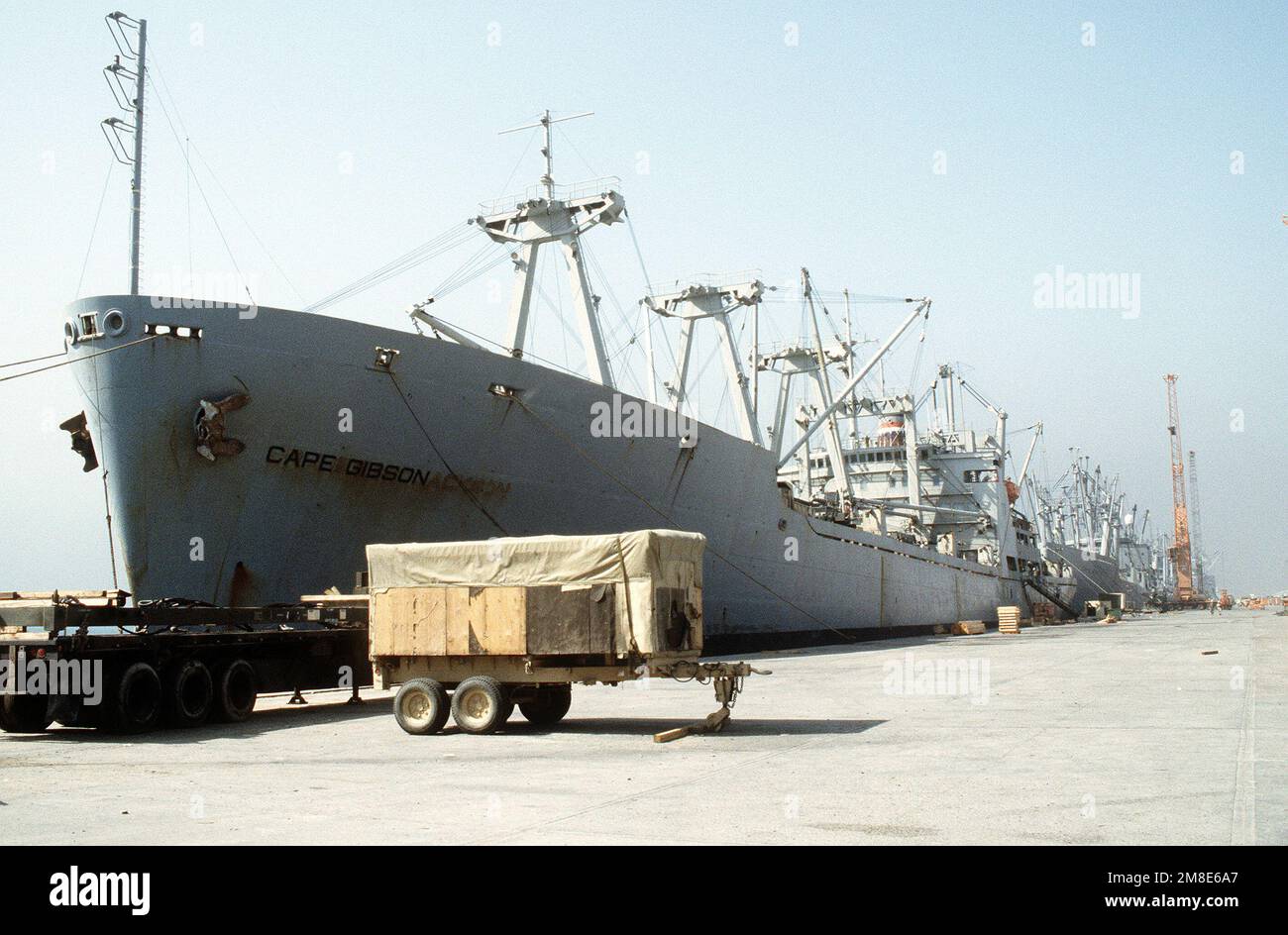 The cargo ship USNS CAPE GIBSON (T-AK-5051) stands moored to the pier ...