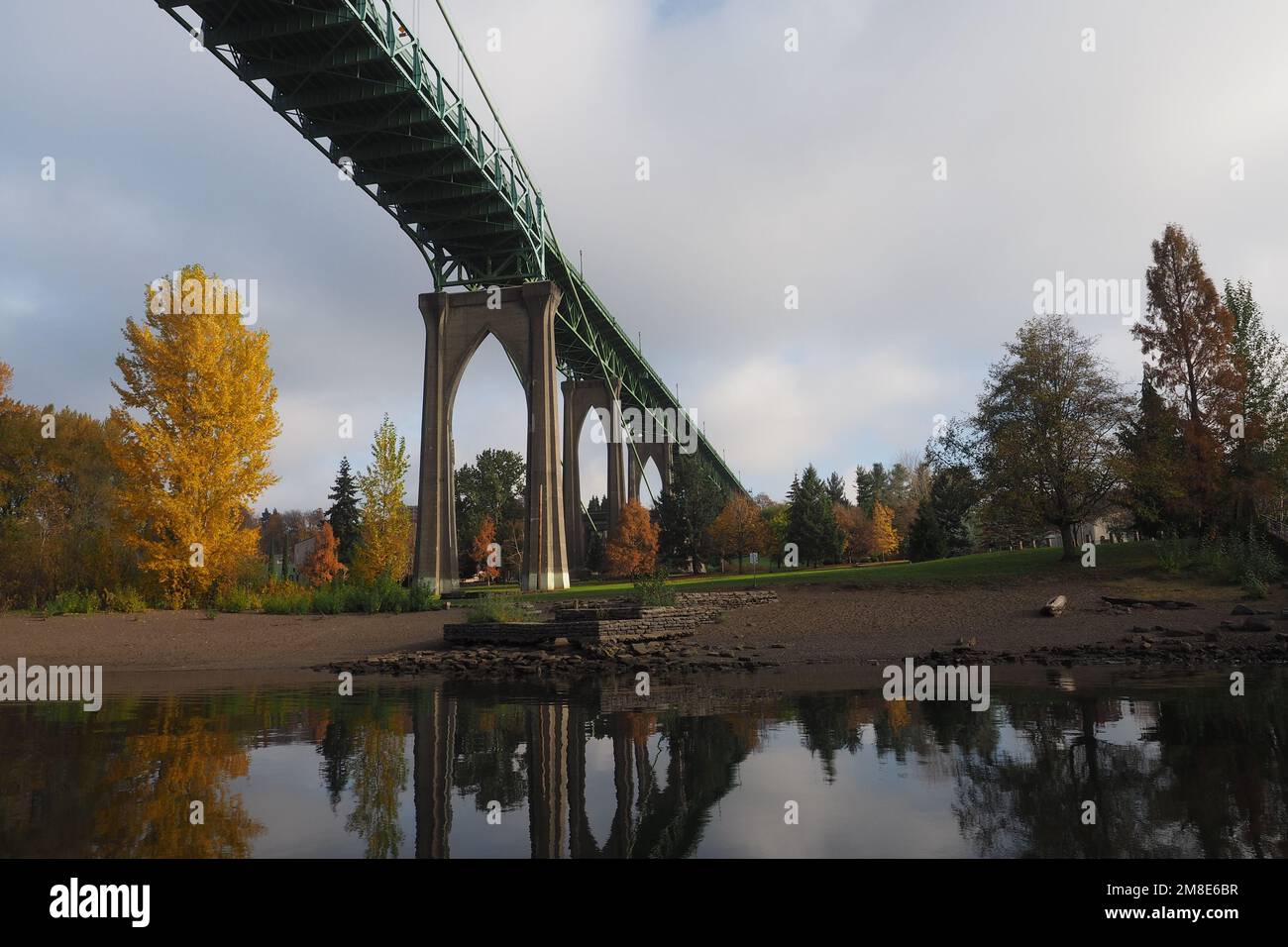 Water reflection of St. Johns Bridge during Fall at Cathedral Park in ...
