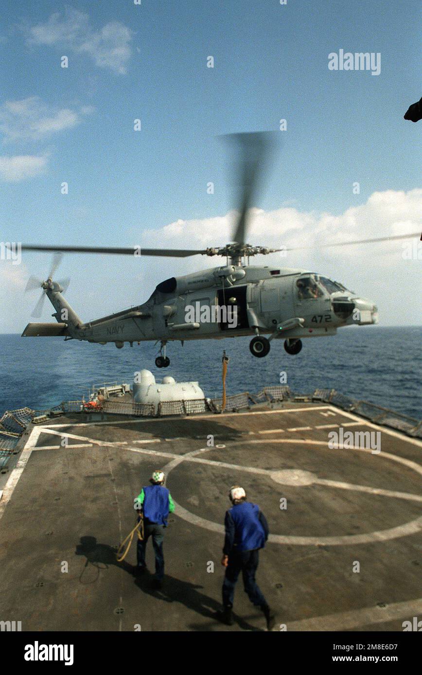 Flight deck crewmen aboard the guided missile cruiser USS BIDDLE (CG-34 ...