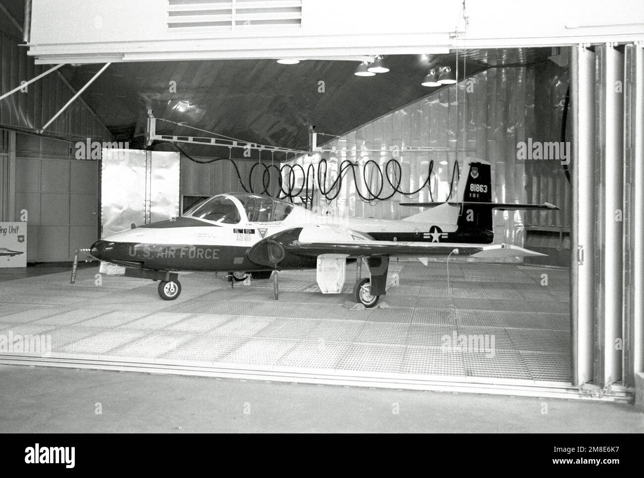 A T-37B Tweet aircraft is parked in a paint booth after receiving a ...