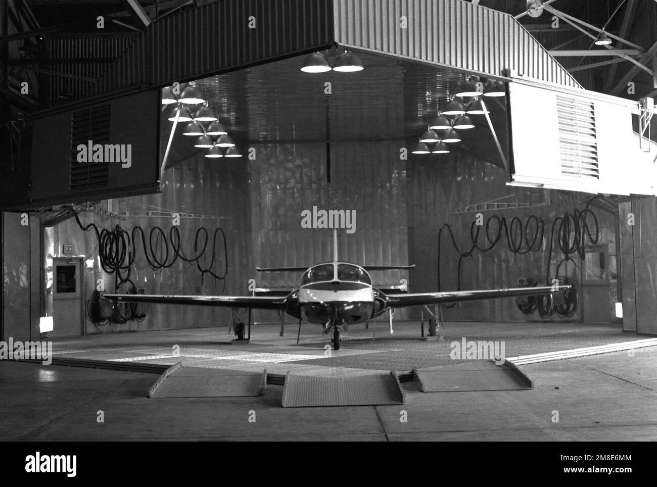 A T-37B Tweet aircraft is parked in a paint booth after receiving a ...