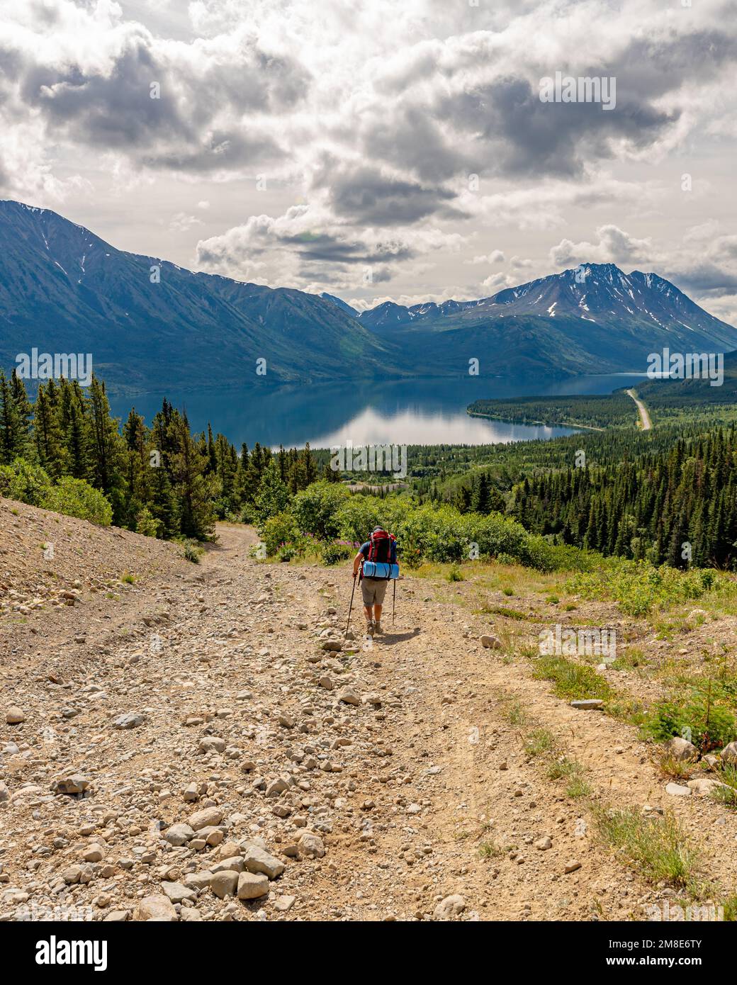 Hiking man in wilderness outdoors area in the back country of Yukon ...