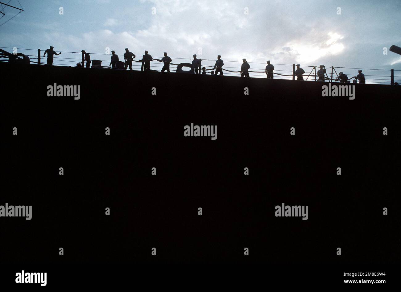 Crew members aboard the battleship USS MISSOURI (BB 63) handle a ...