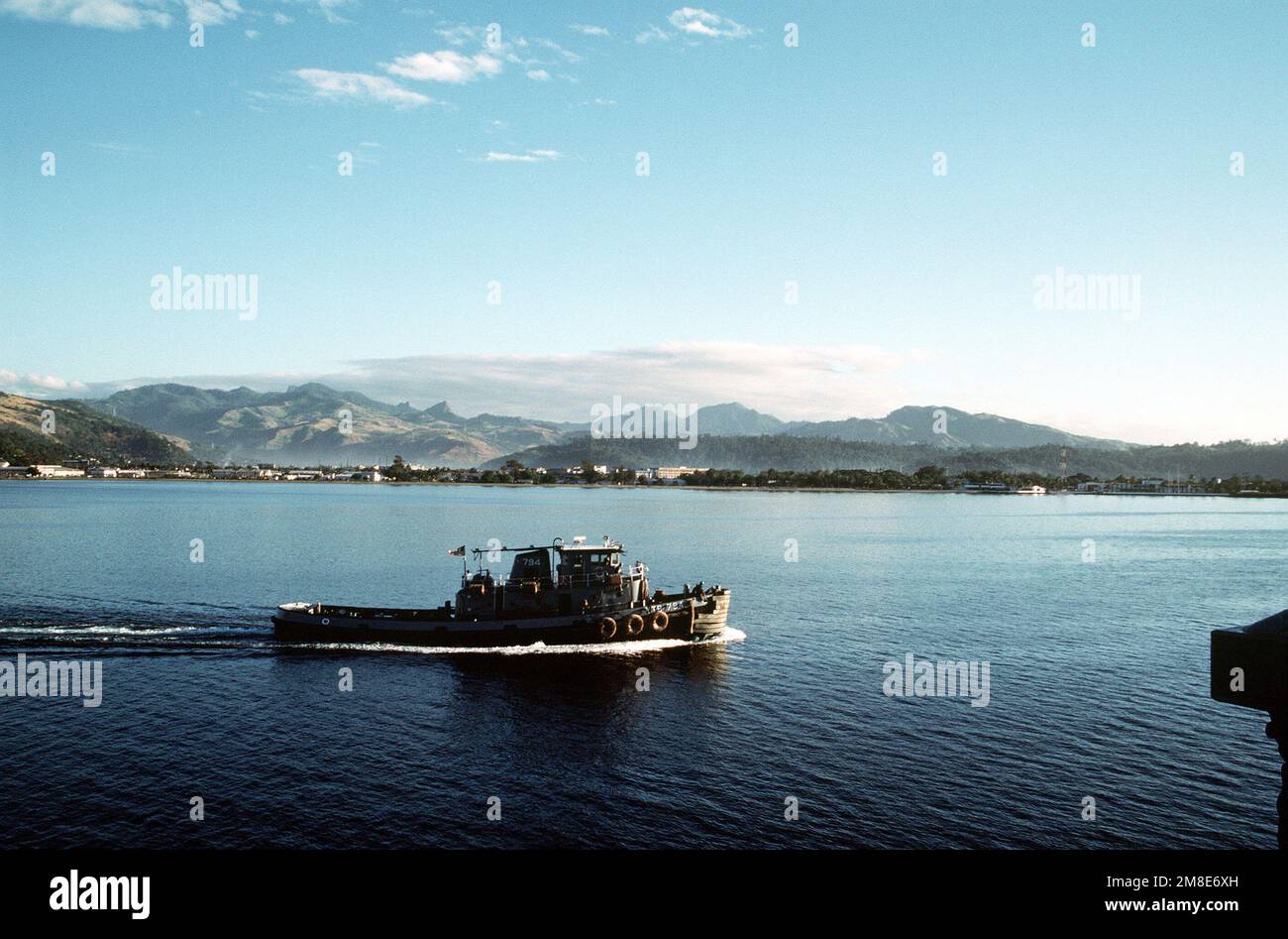 A starboard beam view of the large harbor tug MANDAN (YTB 794) underway ...