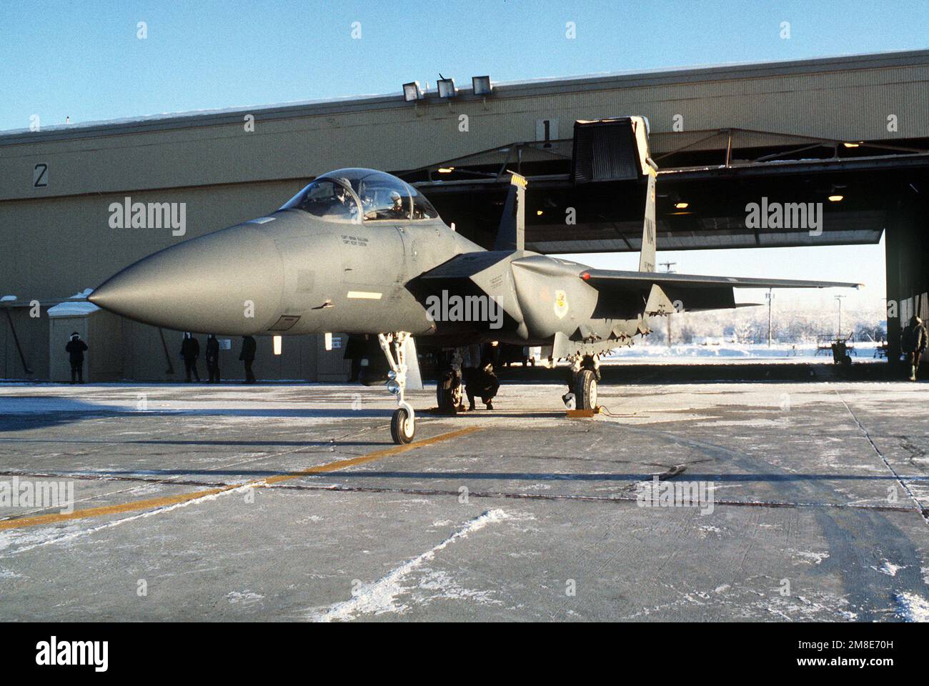 Ground crewmen remove the chocks from the rear wheels of a 57th Fighter ...