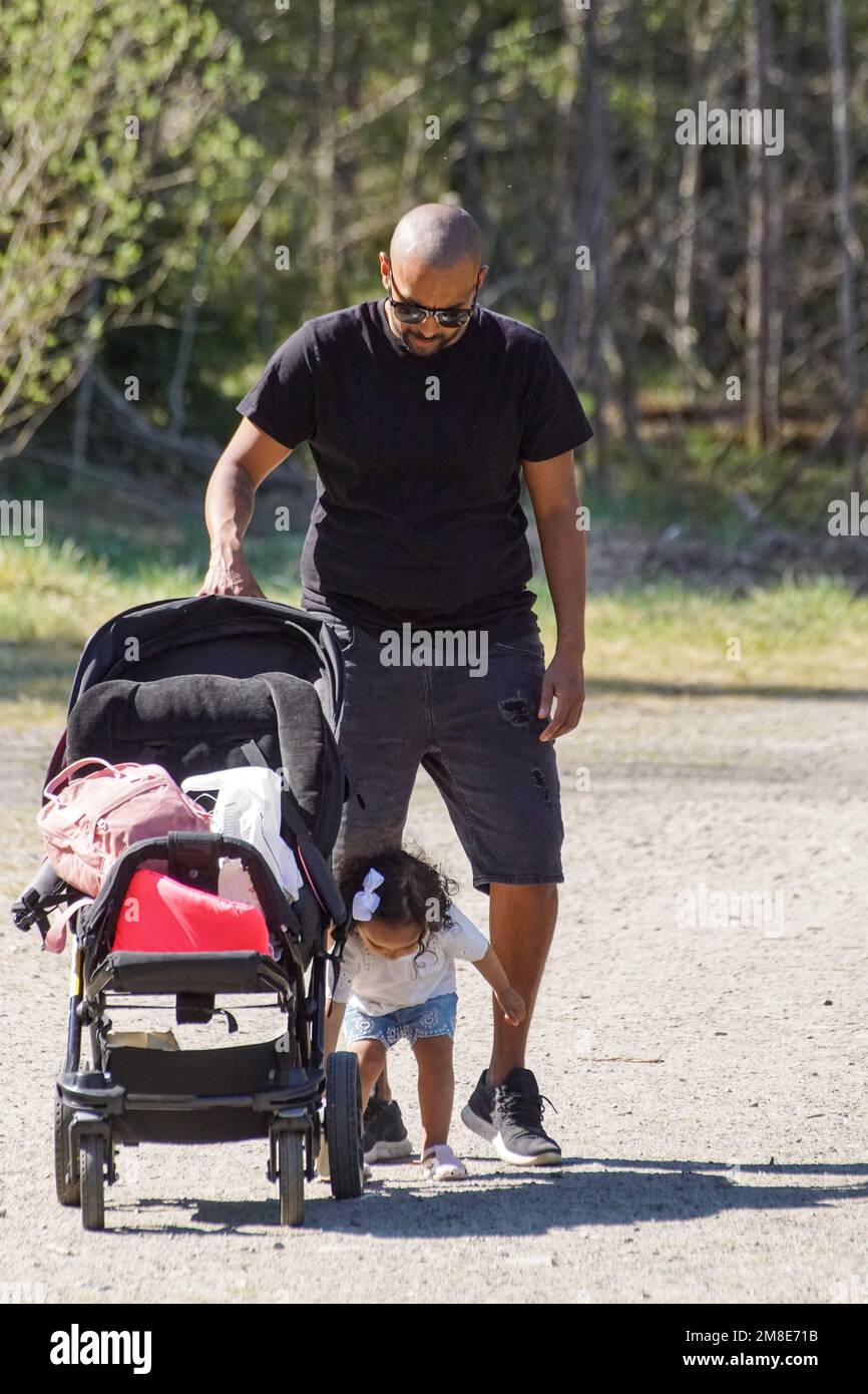Father with stroller standing with child on a road Stock Photo - Alamy