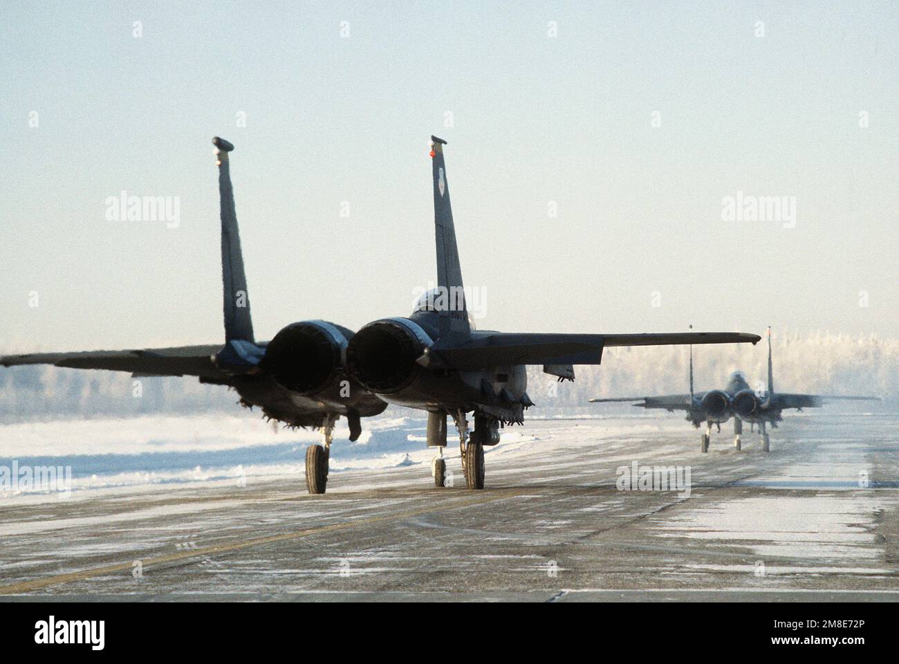 Two 57th Fighter Weapons Wing F-15E Eagle aircraft taxi out to the ...