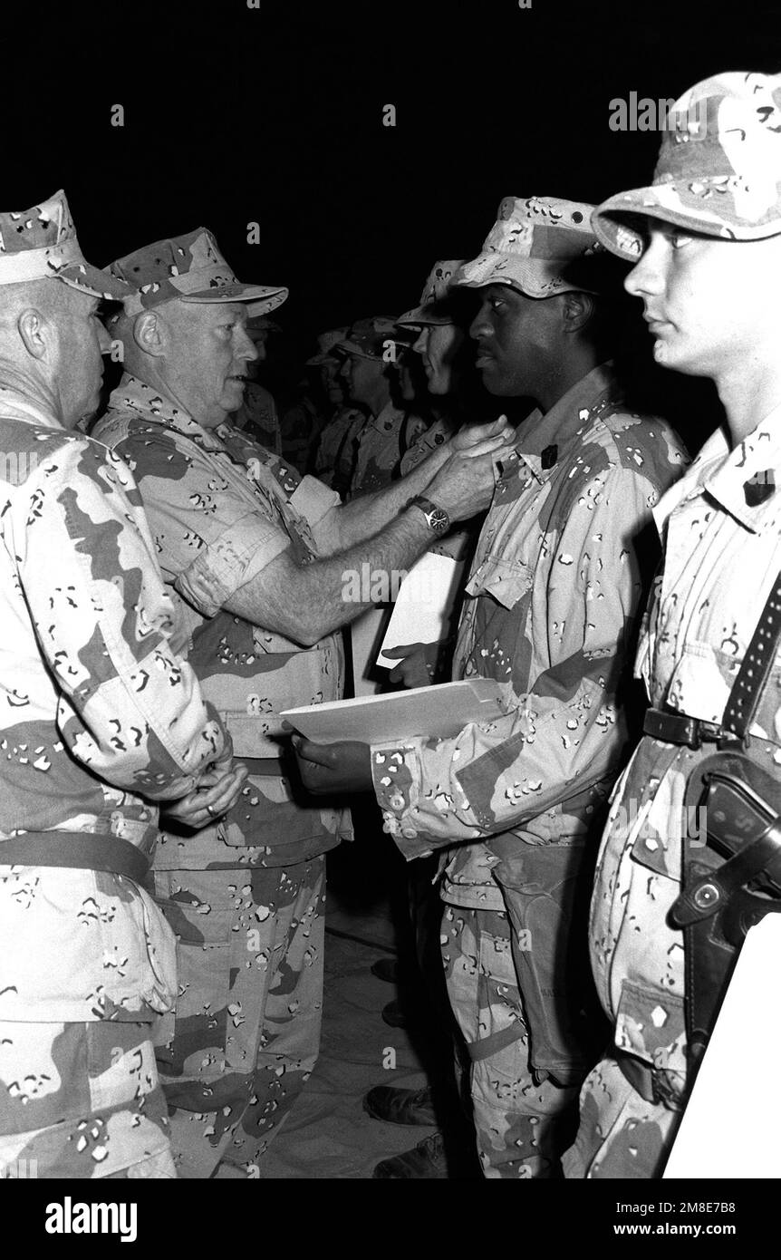 GEN. Alfred M. Gray, commandant of the Marine Corps, attaches a chevron ...