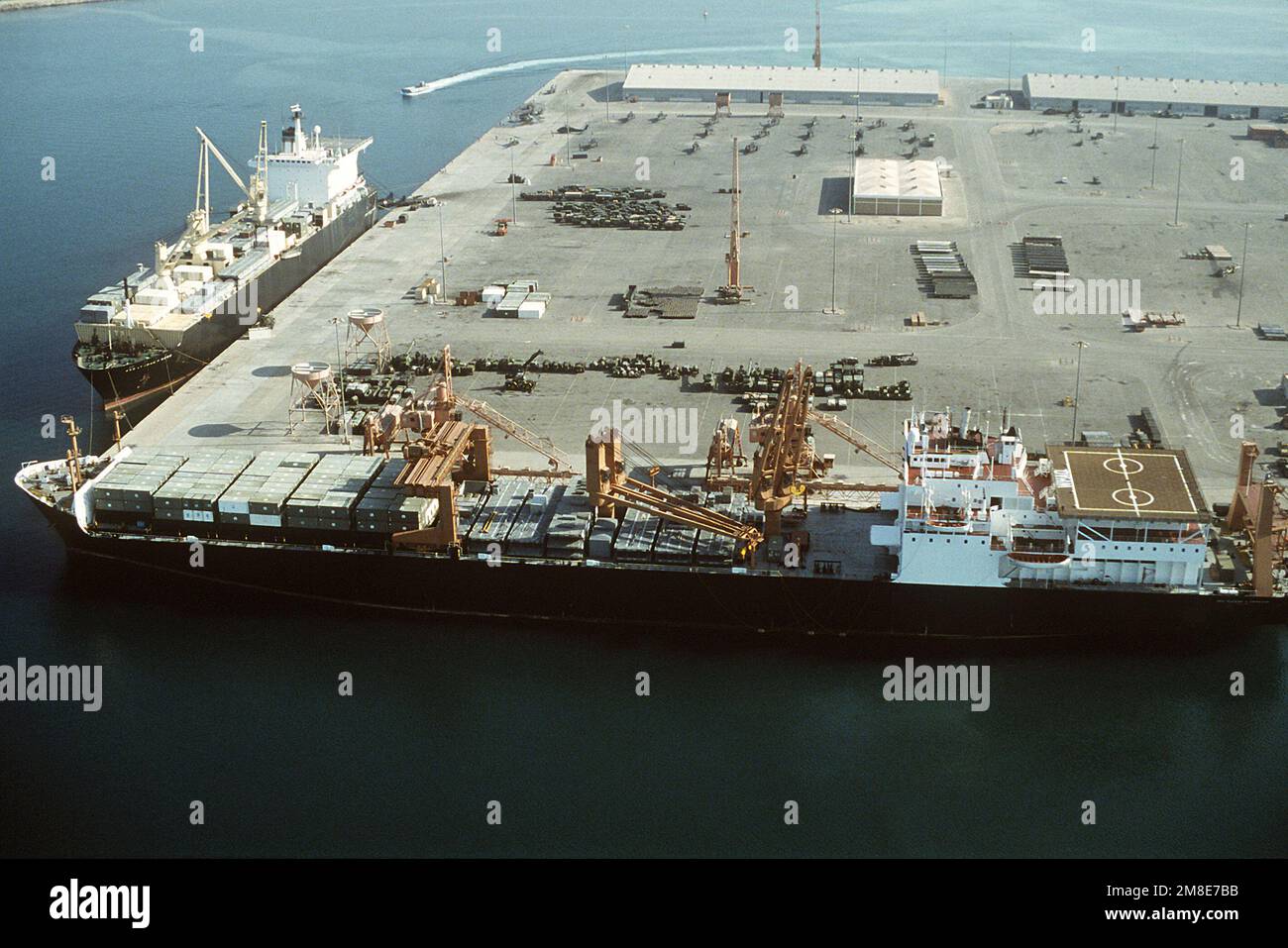 The Vehicle Cargo Ships PFC. EUGENE A. OBREGON (T-AK-3006), foreground ...