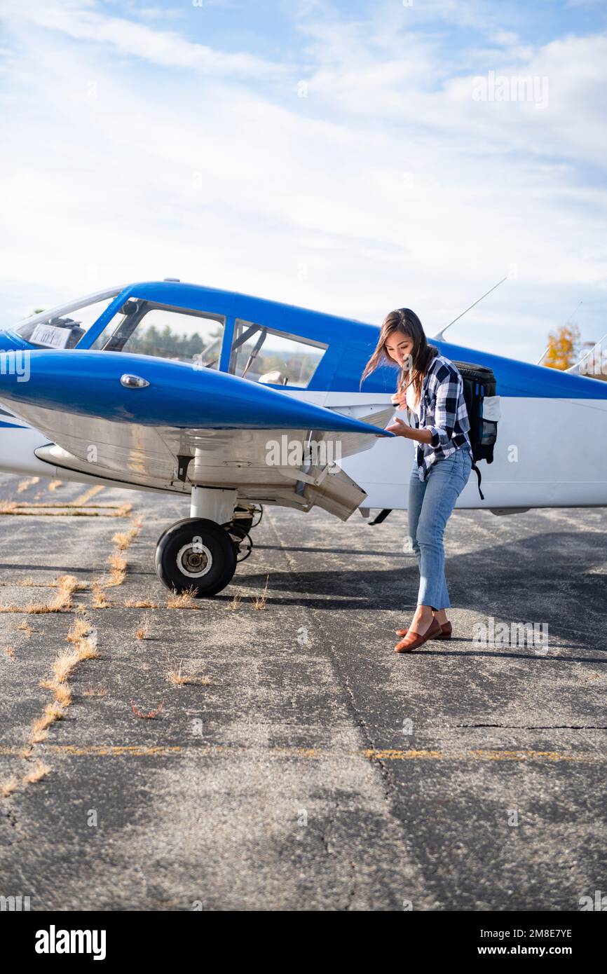 Young BIPOC Female Pilot doing preflight check on small plane Stock ...