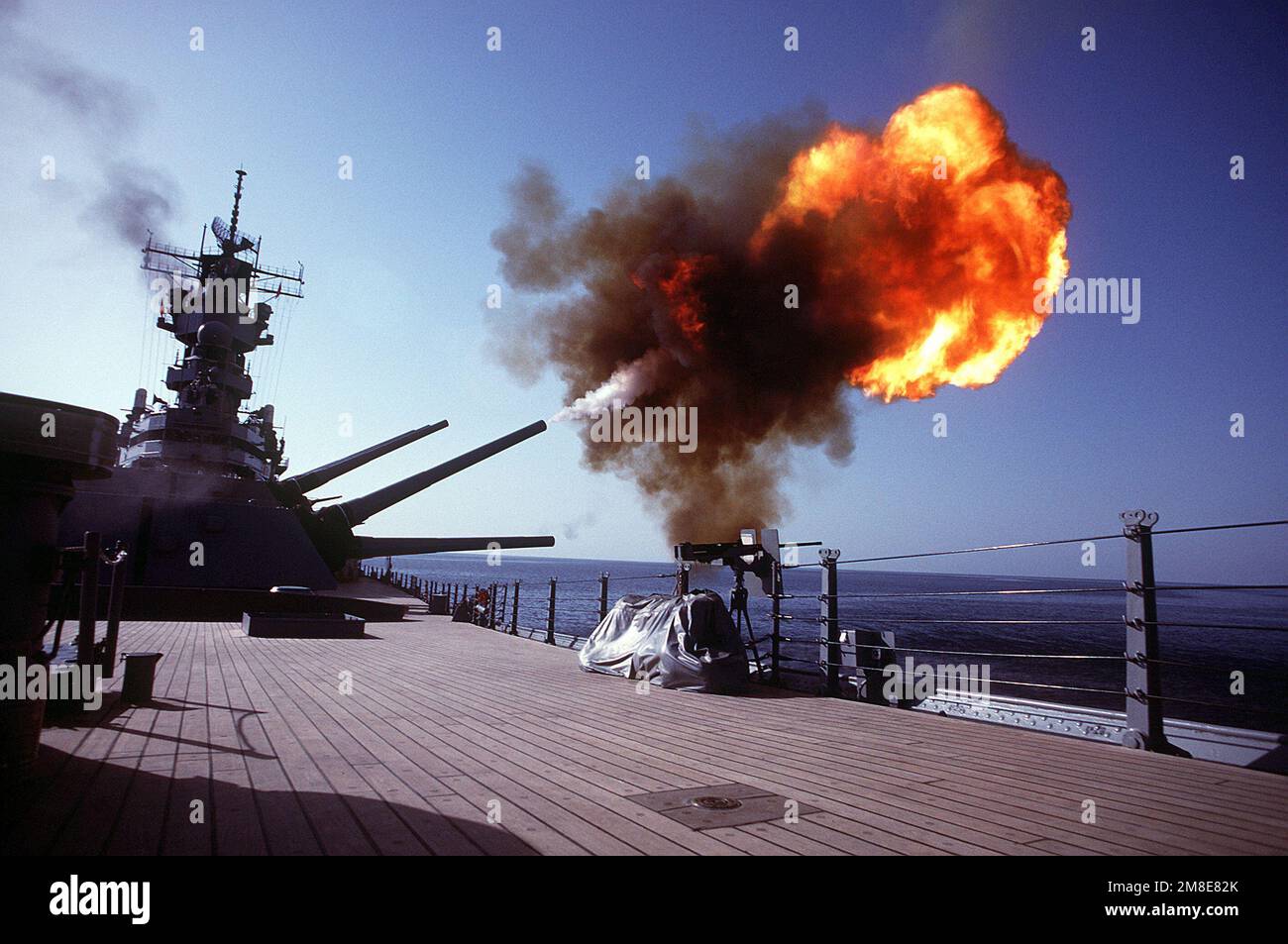 A projectile is fired from a Mark 7 16-inch/50-caliber gun in the No. 1 ...