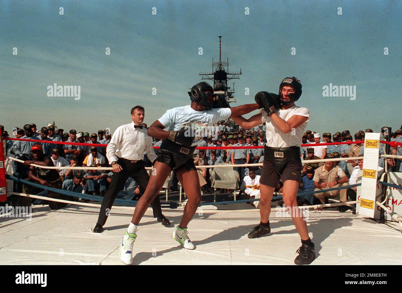 Two boxers trade punches in the ring during a boxing match aboard the ...