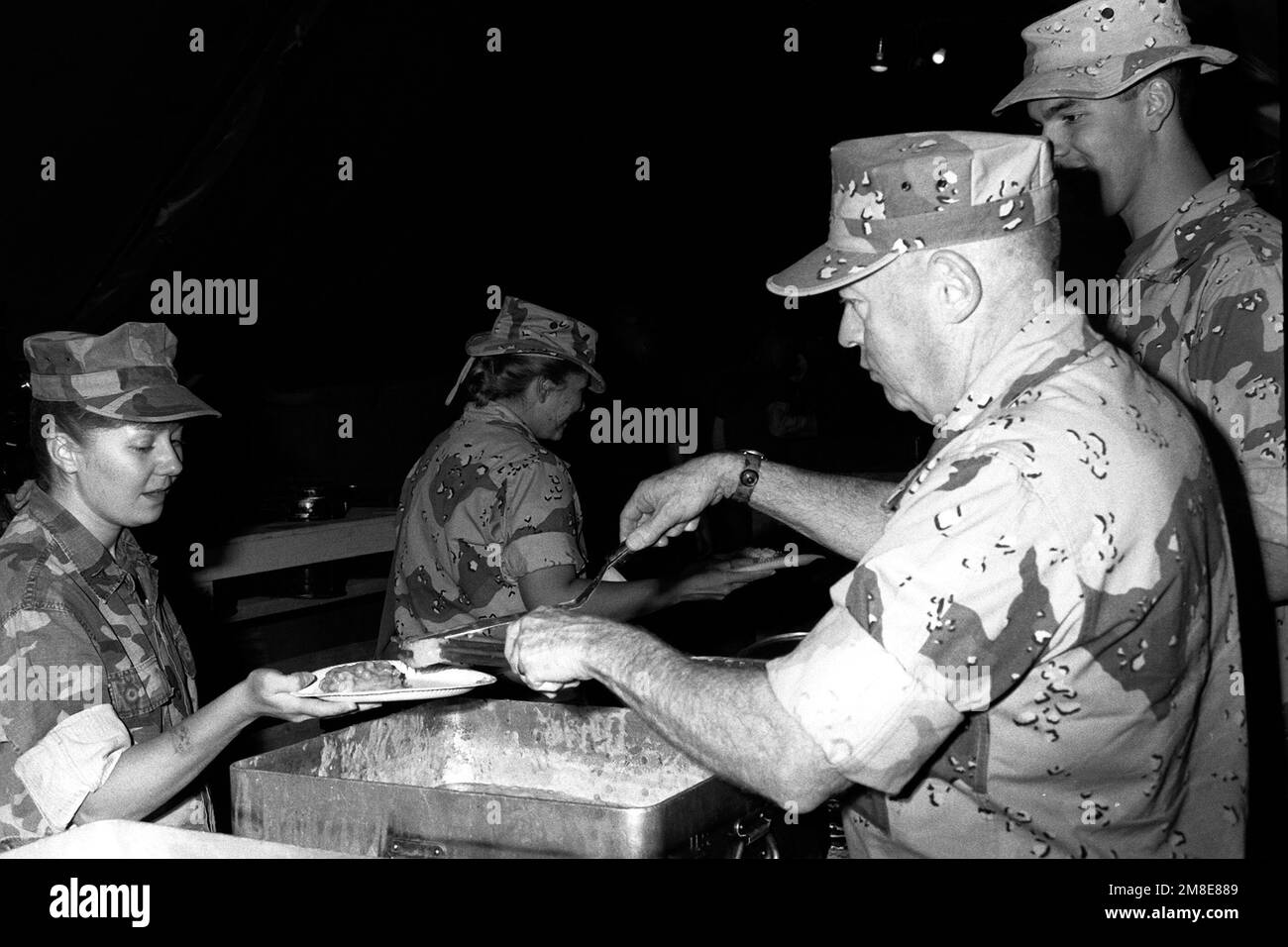 GEN. Alfred M. Gray, commandant of the Marine Corps, serves chow in the ...