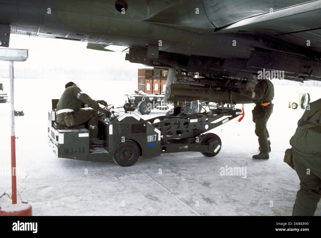 A munitions maintenance specialist uses an MJ-1A weapon loader to ...