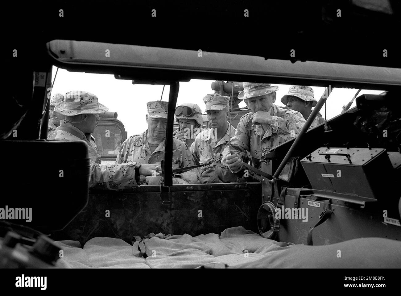 A member of the 3rd Tank Battalion shows the interior of his M998 ...