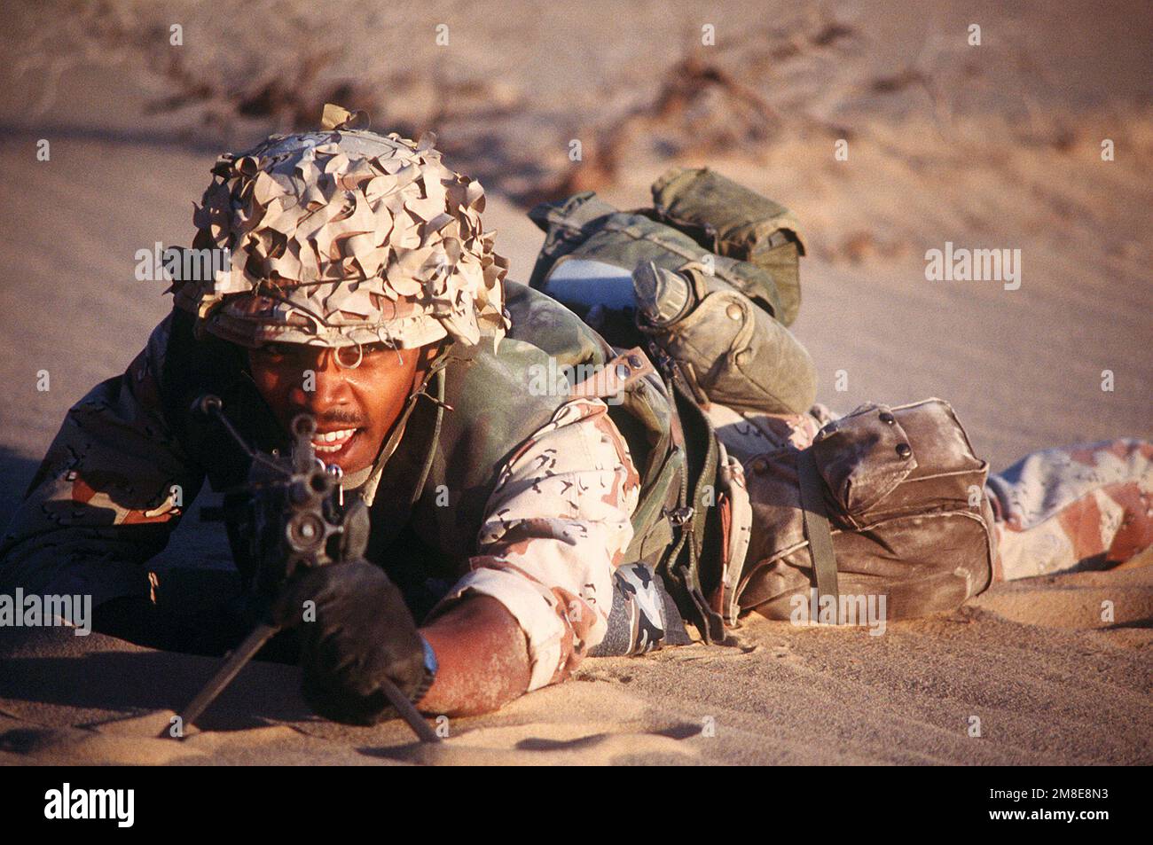 A Marine sights a target with his M-249 squad automatic weapon during ...
