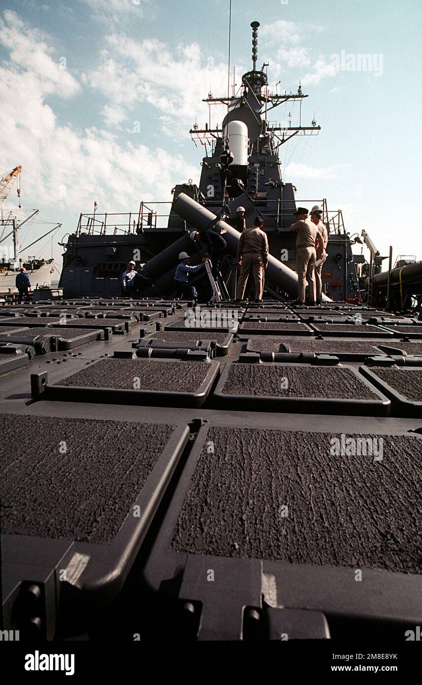 A Harpoon missile canister launcher is lowered into place aboard the ...