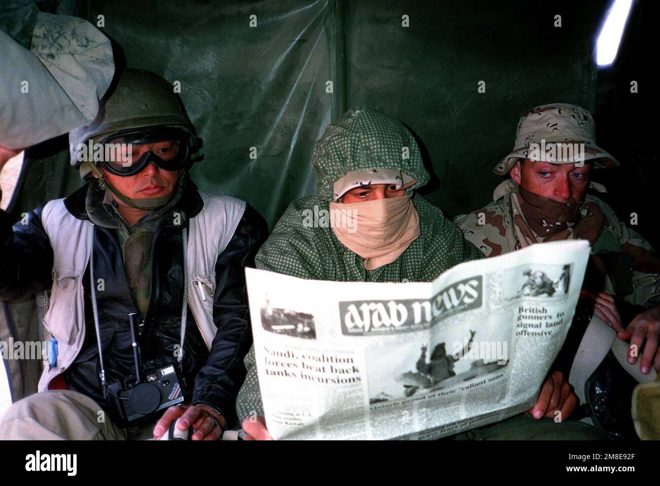 Salim I. Aridi of ABC News, center, shares his newspaper with two other ...