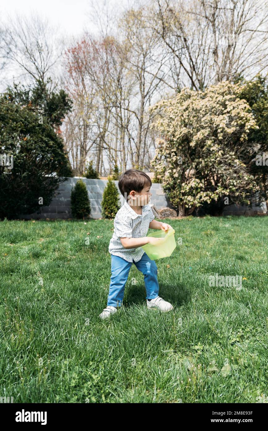 Little boy searching for eggs on easter Stock Photo - Alamy