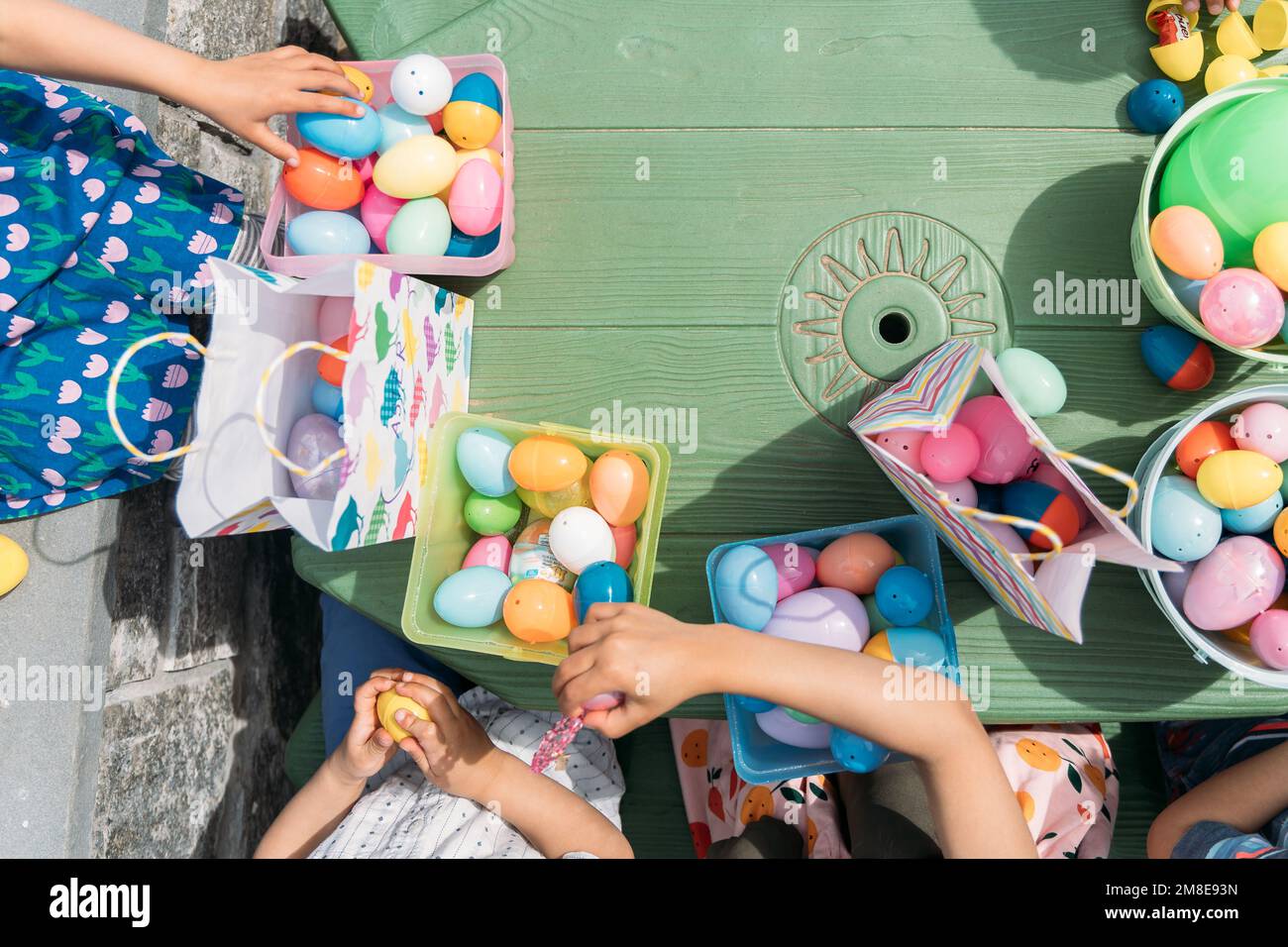 Kids sharing candy after Easter egg hunt Stock Photo - Alamy