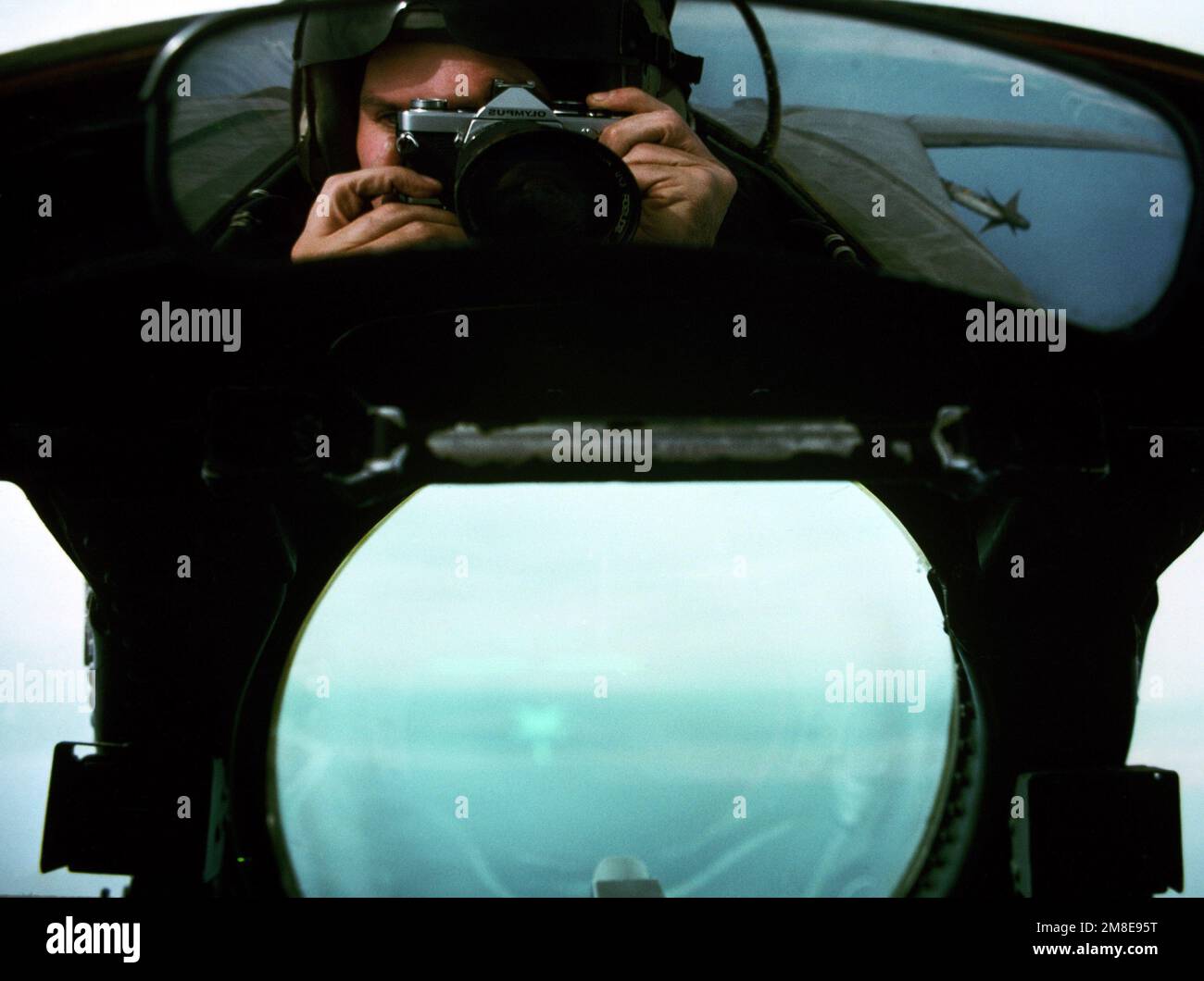 LCDR Ken Neubauer of Fighter Squadron 33 (VF-33) is reflected in the ...