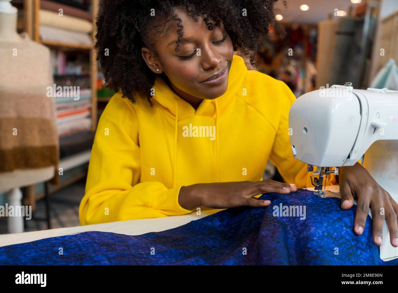 African american girl in her sewing workshop Stock Photo - Alamy
