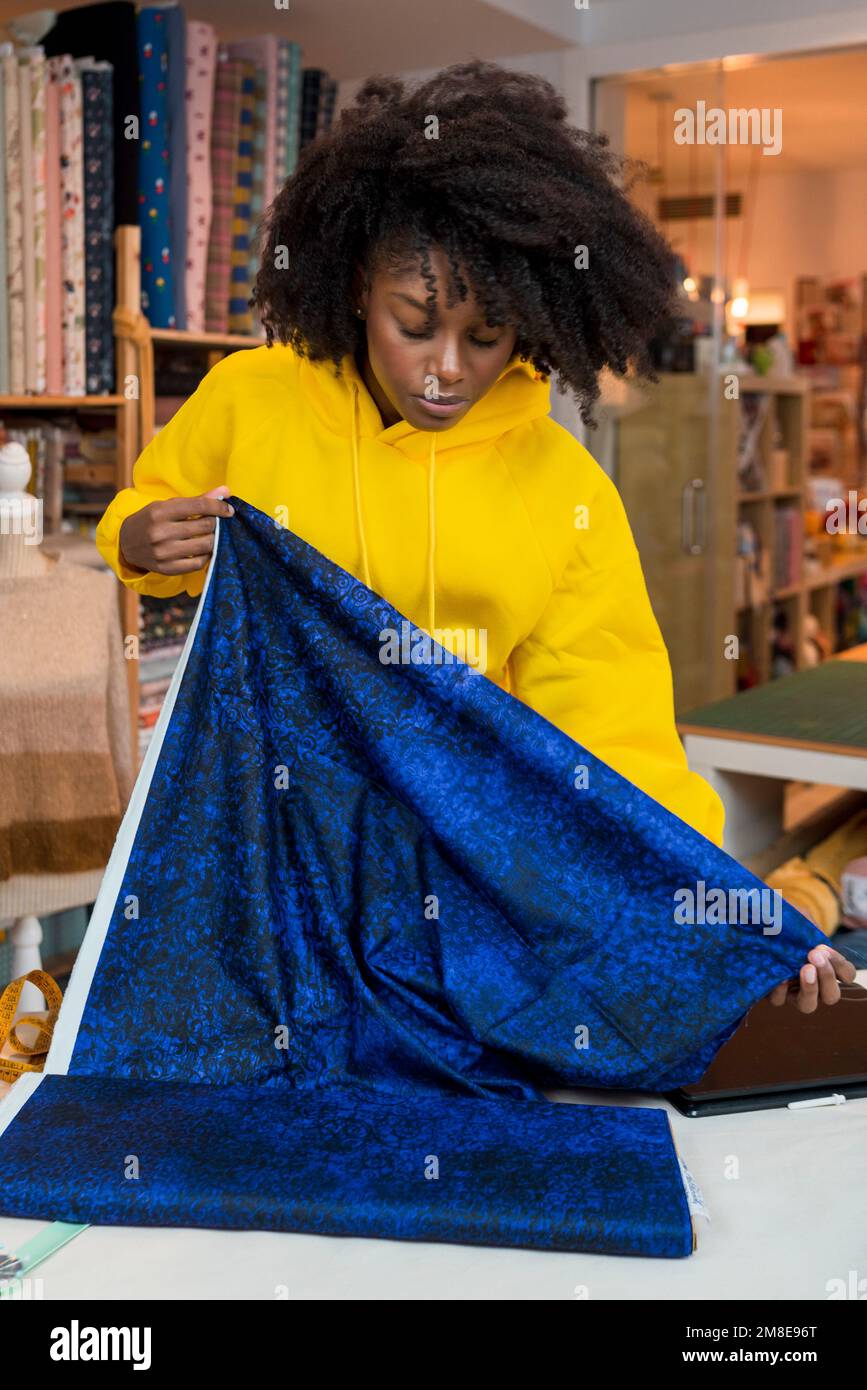 African american girl in her sewing workshop Stock Photo - Alamy