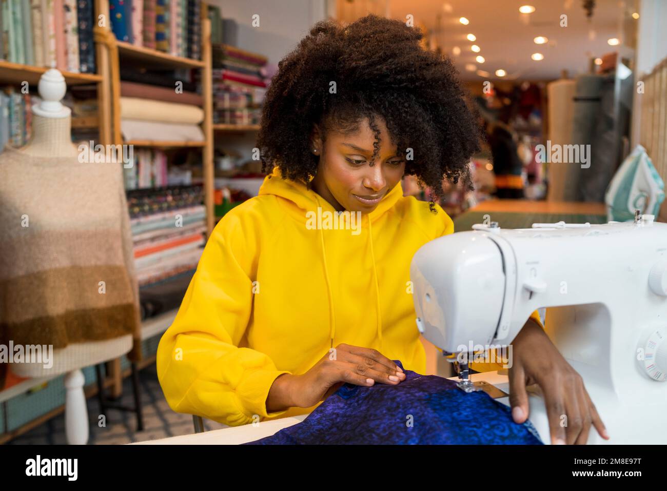 African american girl in her sewing workshop Stock Photo - Alamy