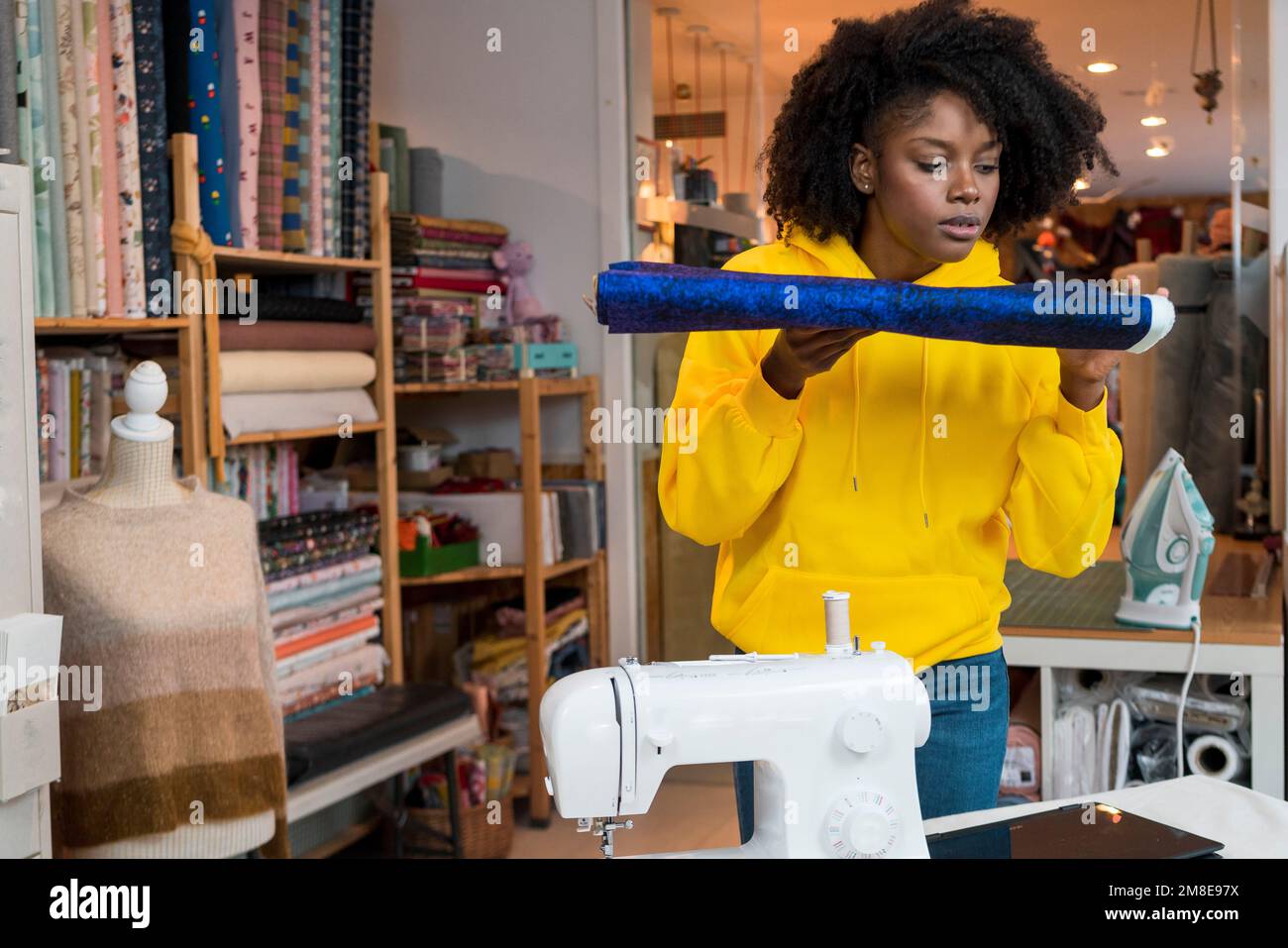 African american girl in her sewing workshop Stock Photo - Alamy