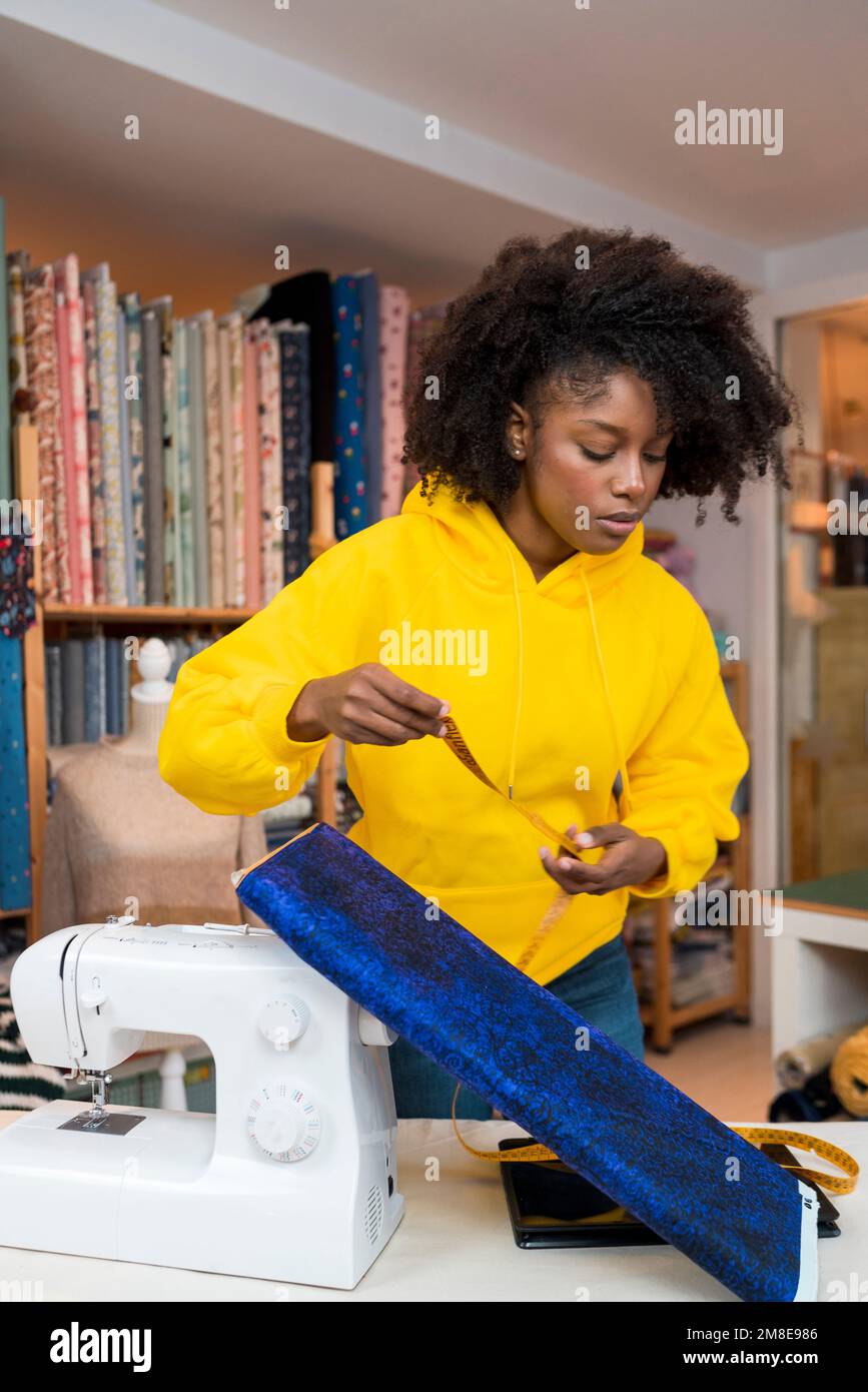 African american girl in her sewing workshop Stock Photo - Alamy