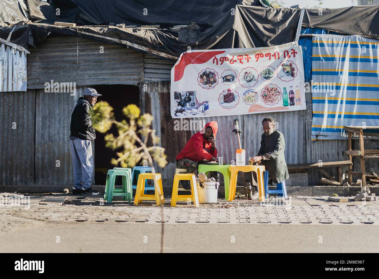 Three men at a hut on the road, photographed in Addis Ababa, January 12 ...