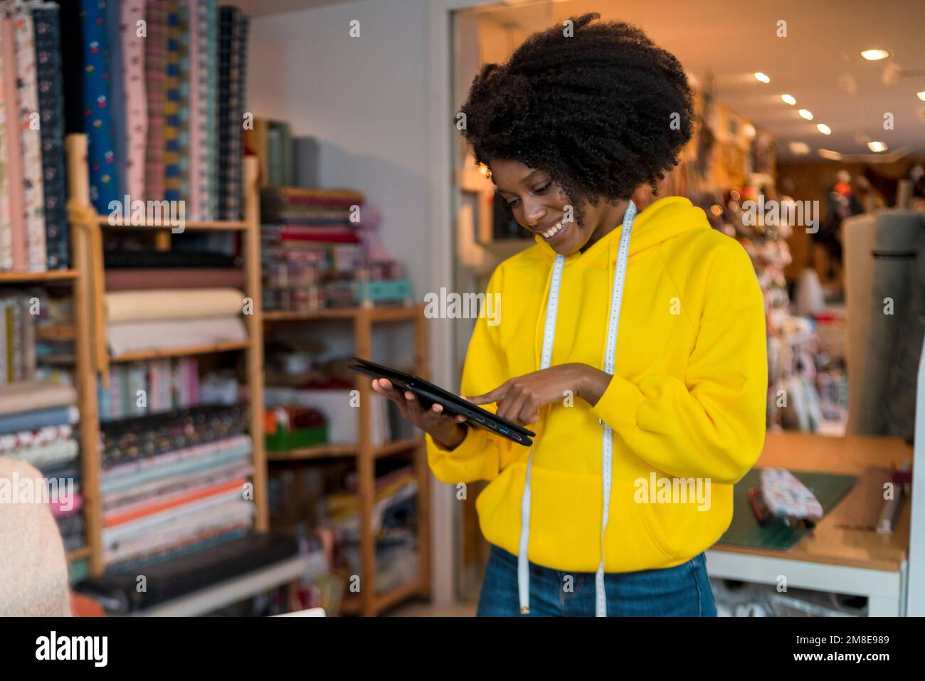 African american girl in her sewing workshop Stock Photo - Alamy