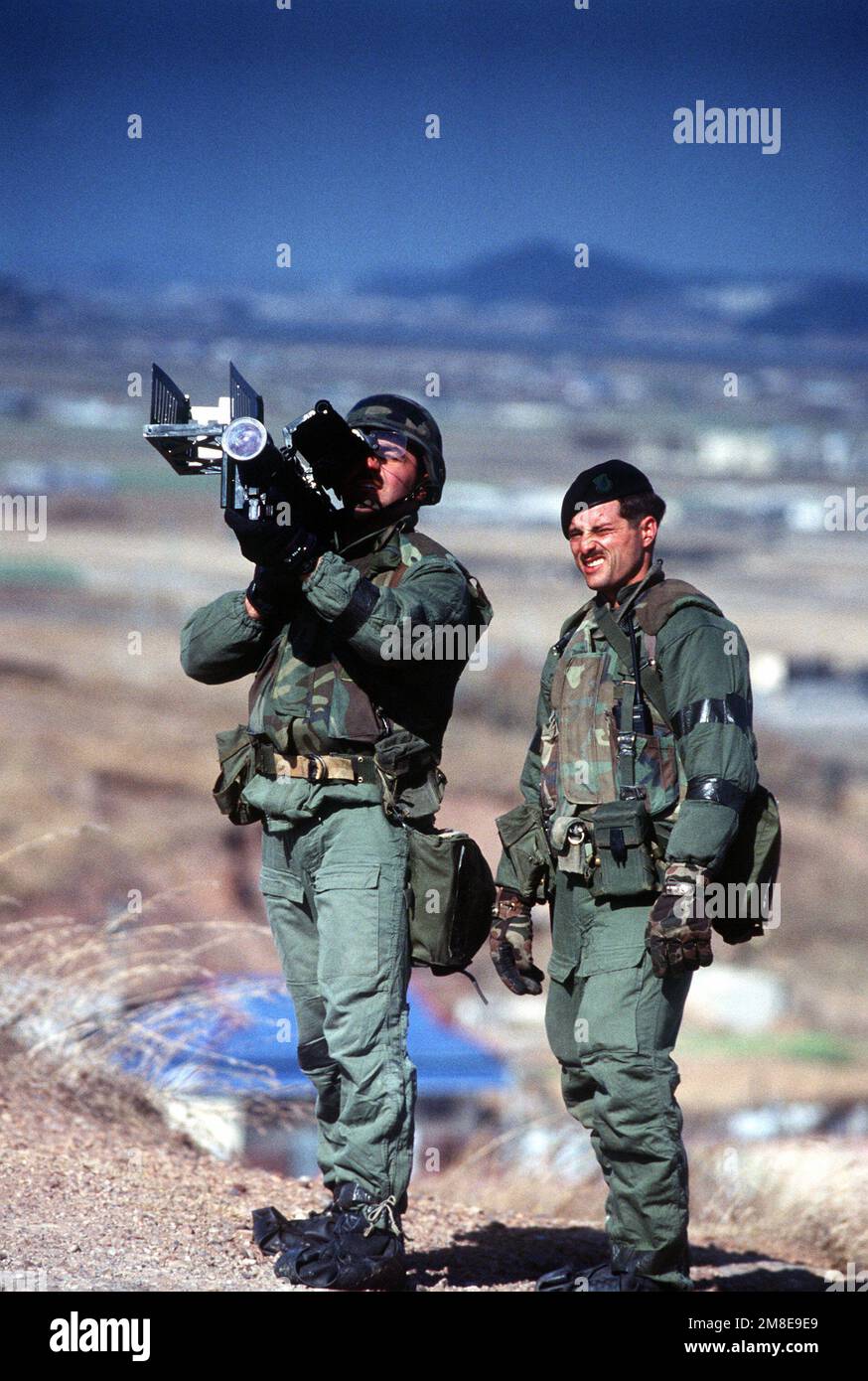 A member of the base's ground defense force tracks a target with a FIM ...