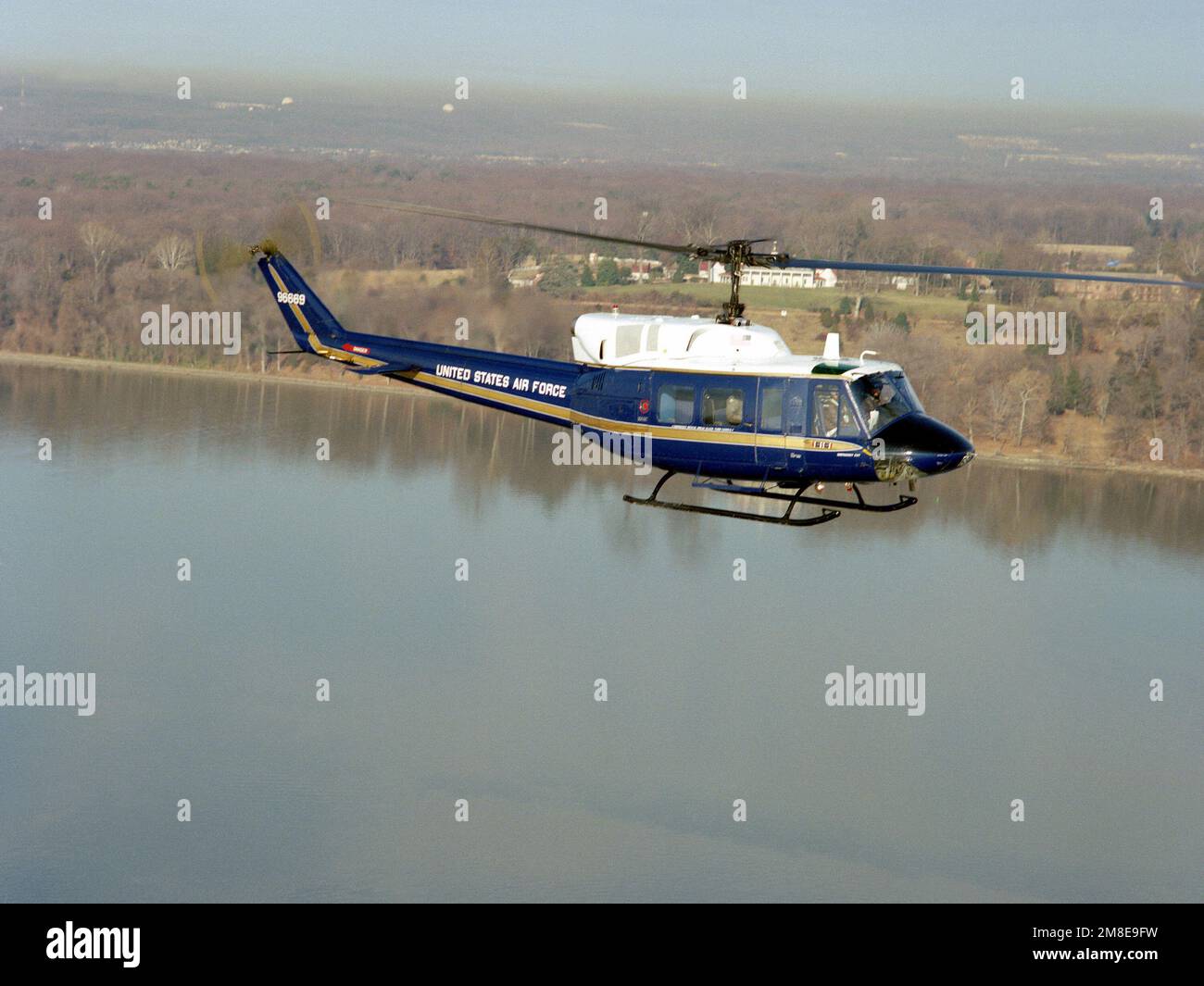 An air-to-air right side view of a UH-1N Iroquois helicopter of the 1ST ...