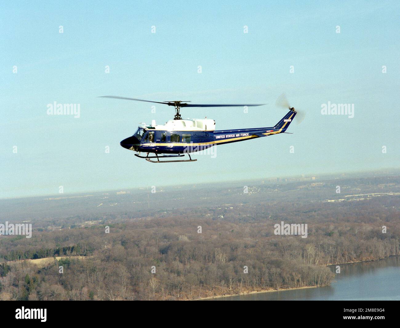 An air-to-air left side view of a UH-1N Iroquois helicopter of the 1ST ...