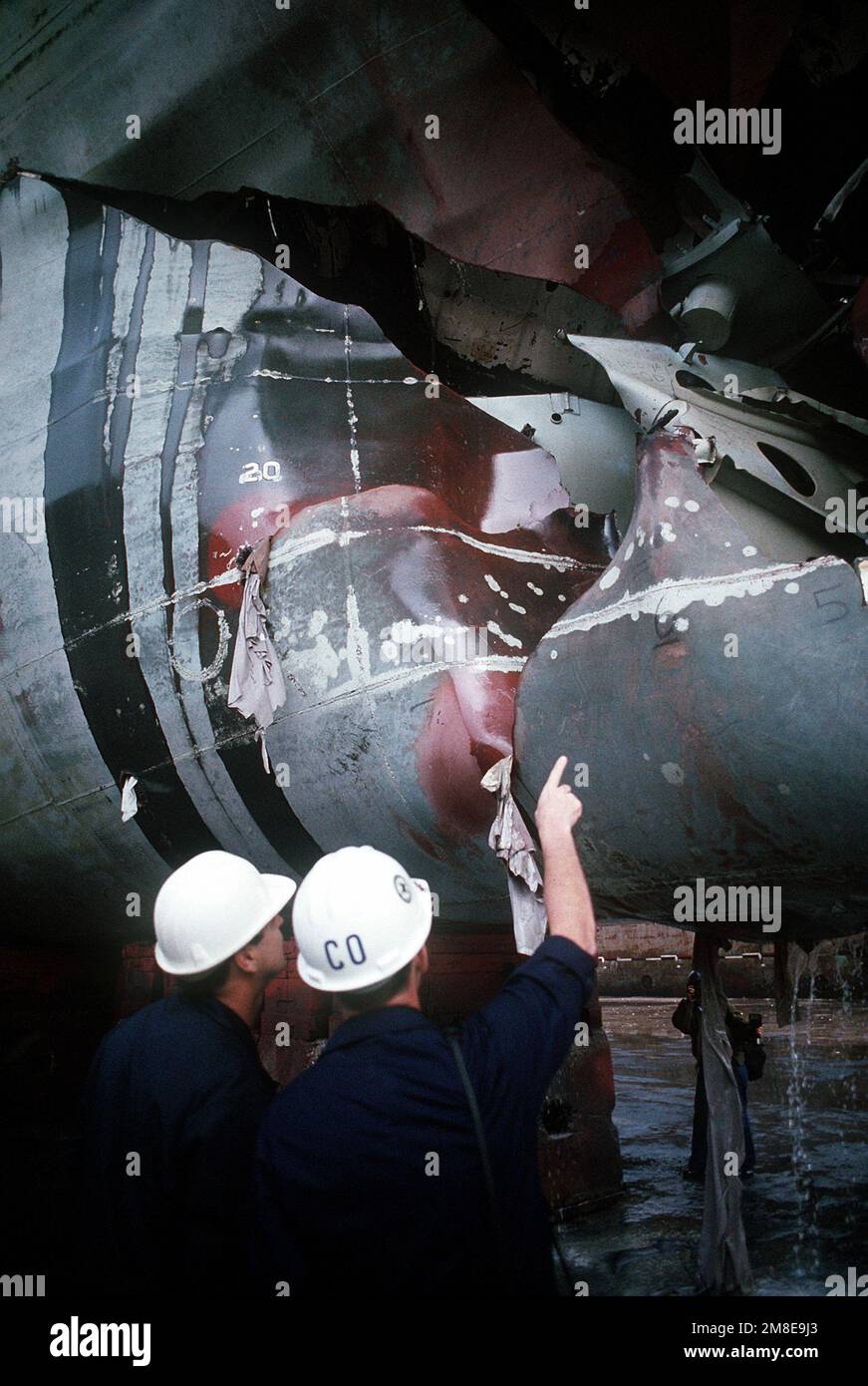 CAPT. G.B. McEwen, right, commanding officer of the amphibious assault ...