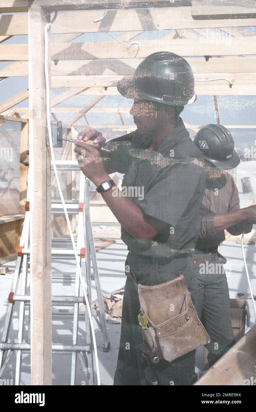 Seabees of Naval Mobile Construction Battalion 74 install electrical ...