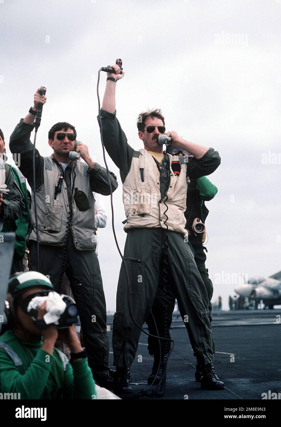 A landing signal officer and his assistant aboard the aircraft carrier ...