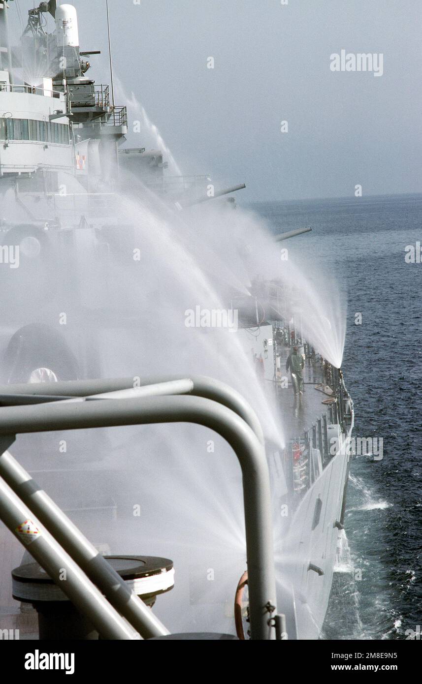 The topside areas of the battleship USS WISCONSIN (BB-64) are sprayed ...