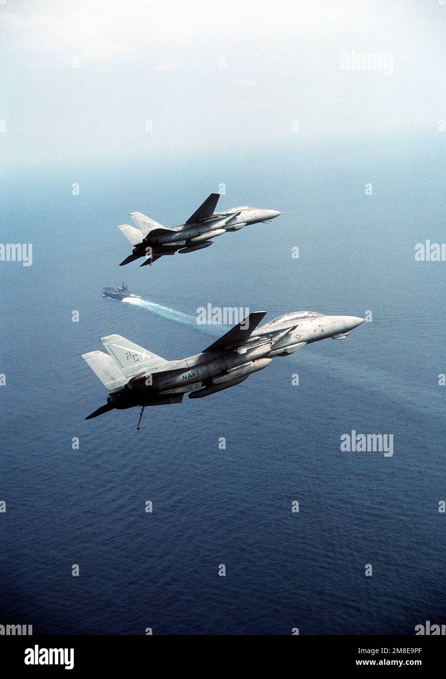 Two Fighter Squadron 32 (VF-32) F-14A Tomcat aircraft turn toward the ...