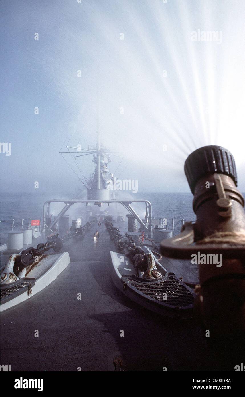 The topside areas of the battleship USS WISCONSIN (BB-64) are sprayed ...