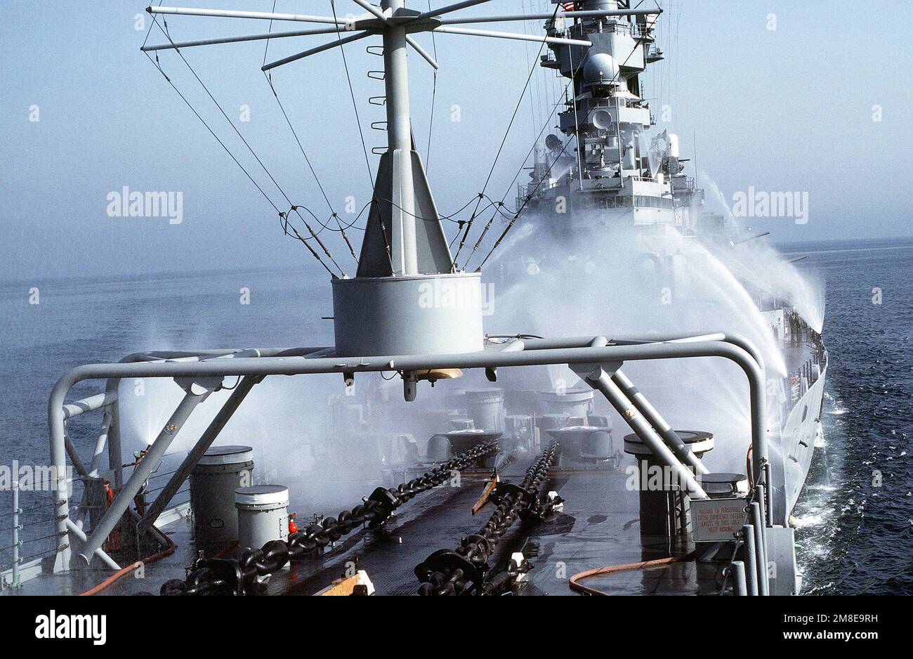 The topside areas of the battleship USS WISCONSIN (BB-64) are sprayed ...