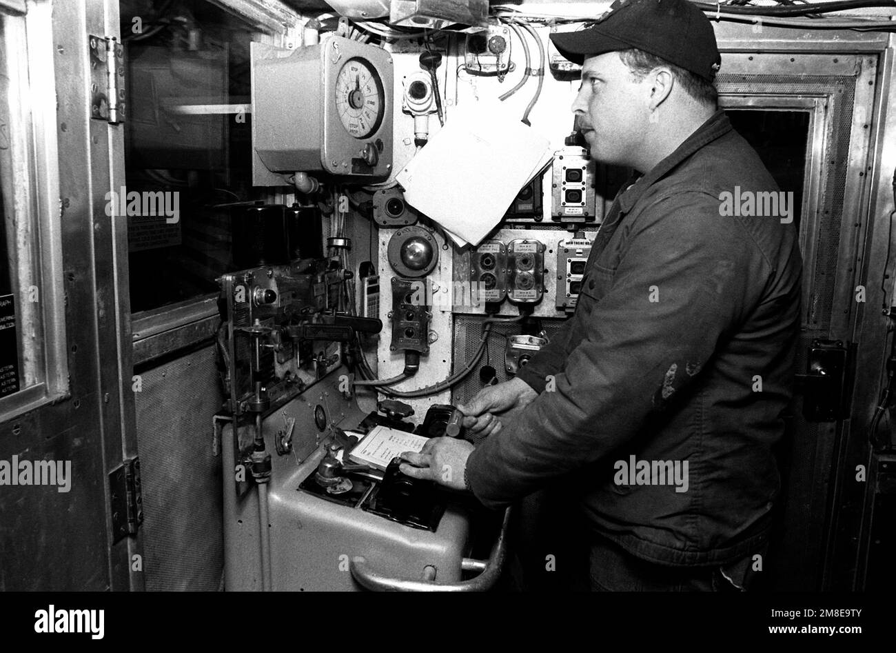 Engineman 2nd Class Edward Hunt monitors the engine speed of the ocean ...