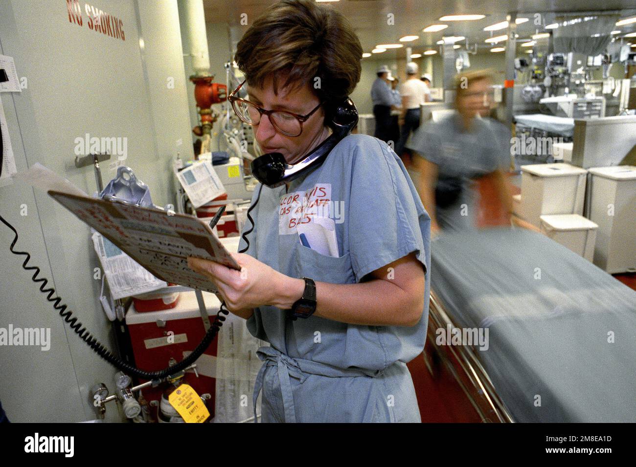 A nurse records information on a chart aboard the hospital ship USNS ...