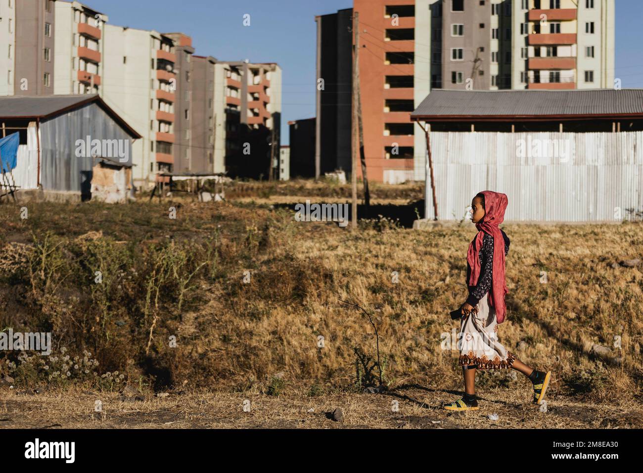 A woman walks in front of a new housing estate, pictured in Addis Ababa ...