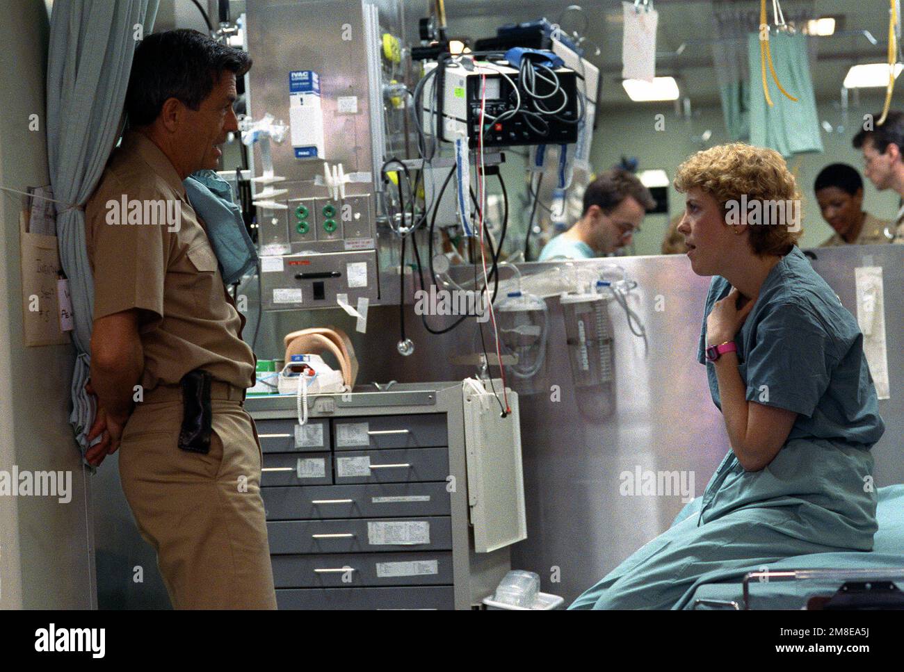 Medical personnel confer aboard the hospital ship USNS COMFORT (T-AH-20 ...