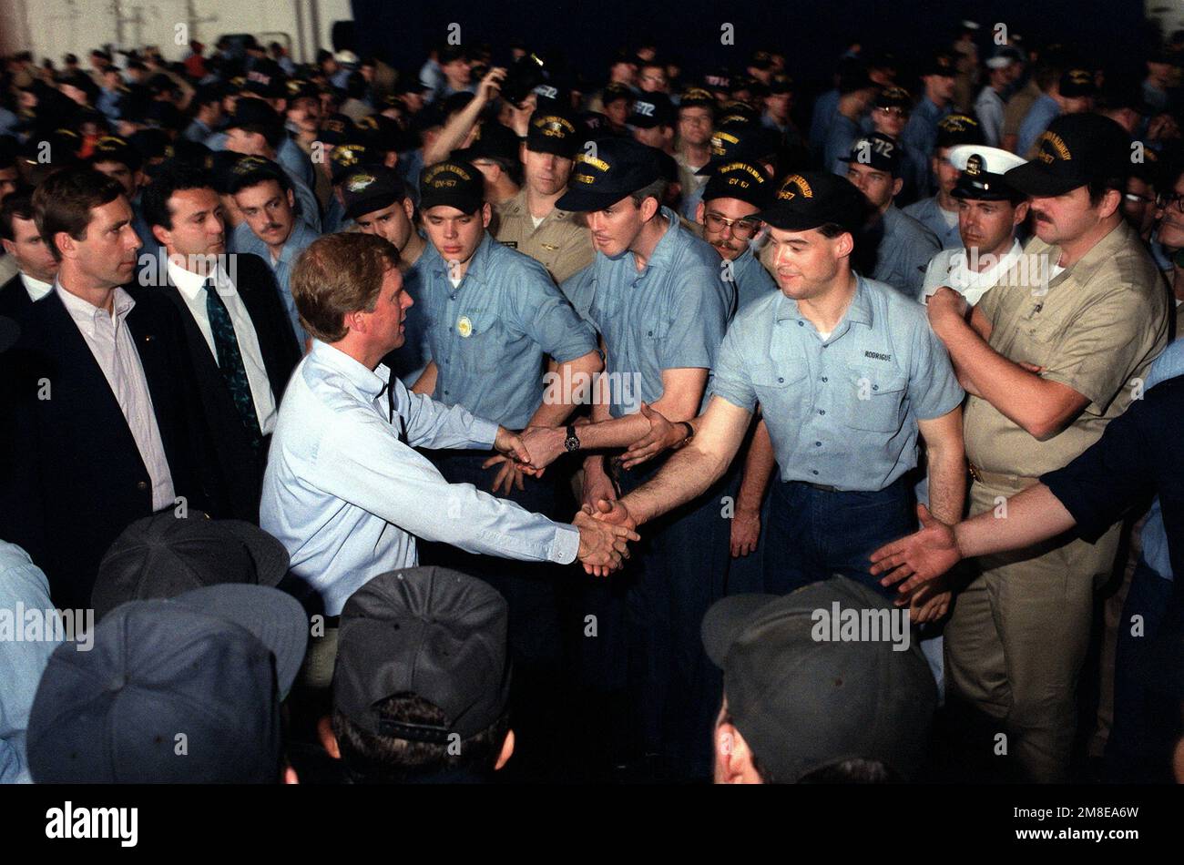Vice President J. Danforth Quayle meets crew members aboard the ...