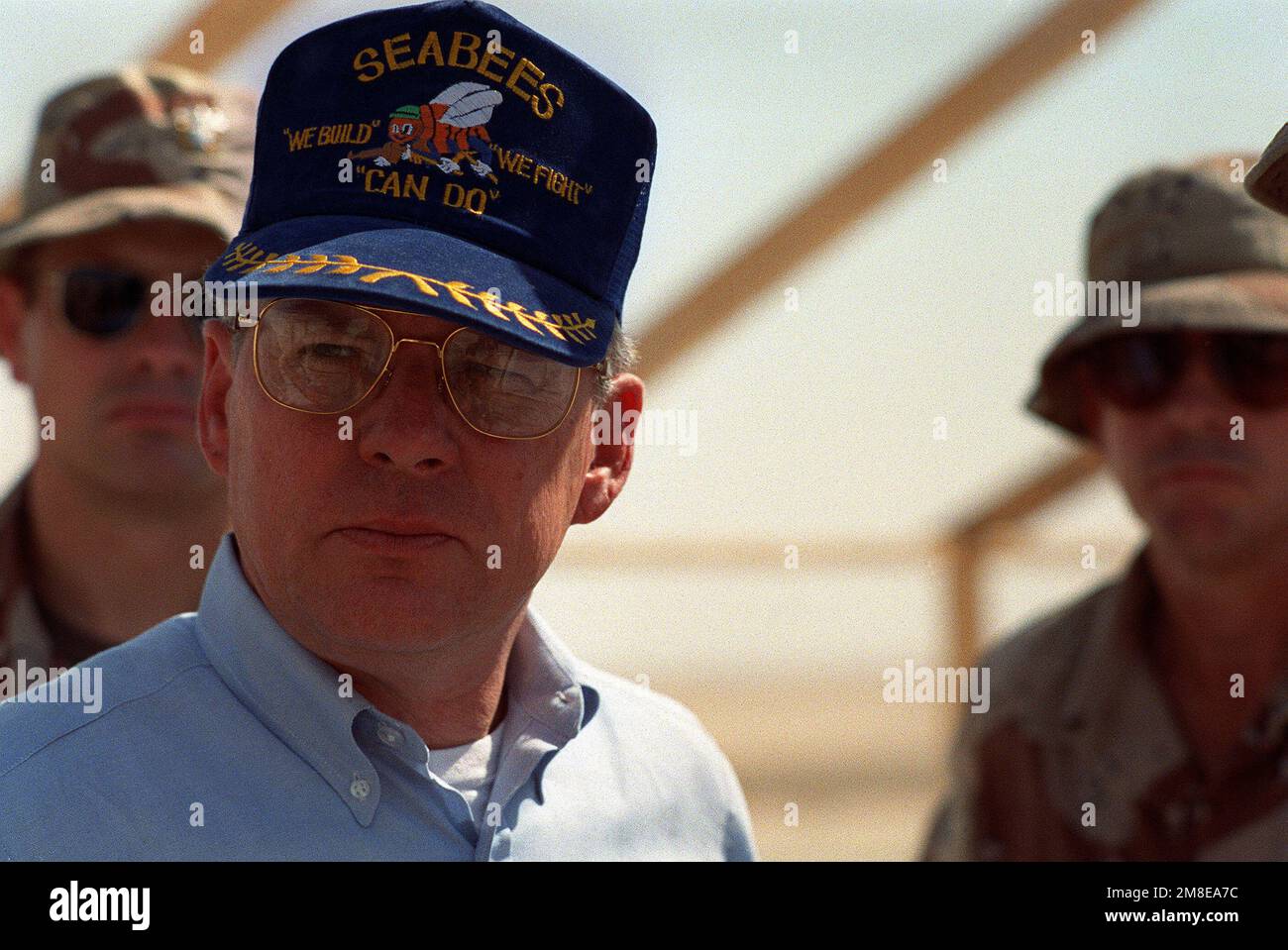 Secretary of the Navy H. Lawrence Garrett III sports a Seabees cap as ...