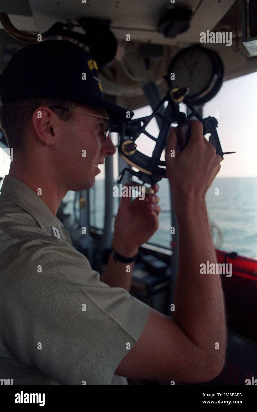 An Officer Aboard The Battleship Uss Wisconsin Bb 64 Takes A Reading With A Sextant The