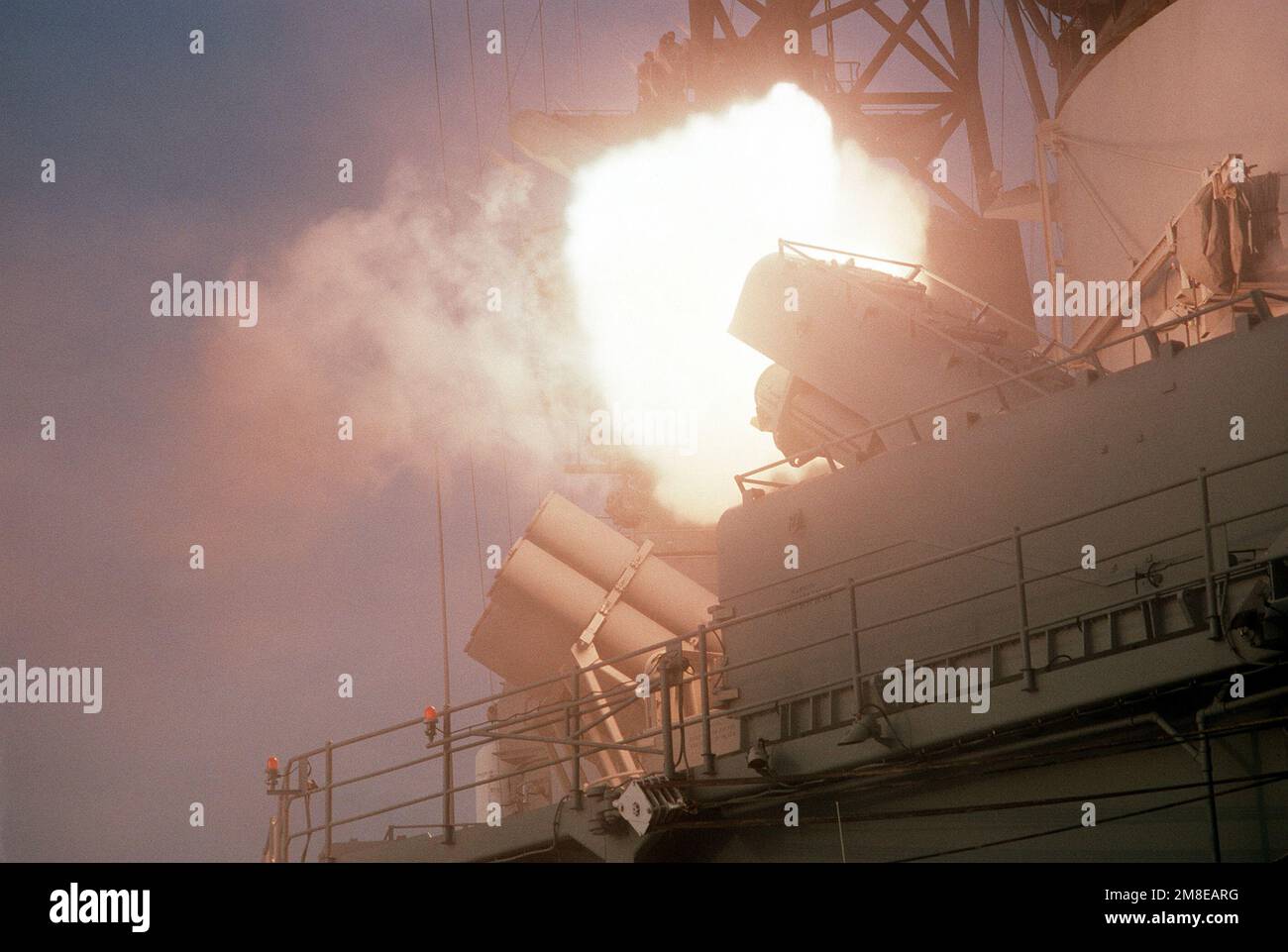 A fireball illuminates the upper decks of the battleship USS WISCONSIN ...